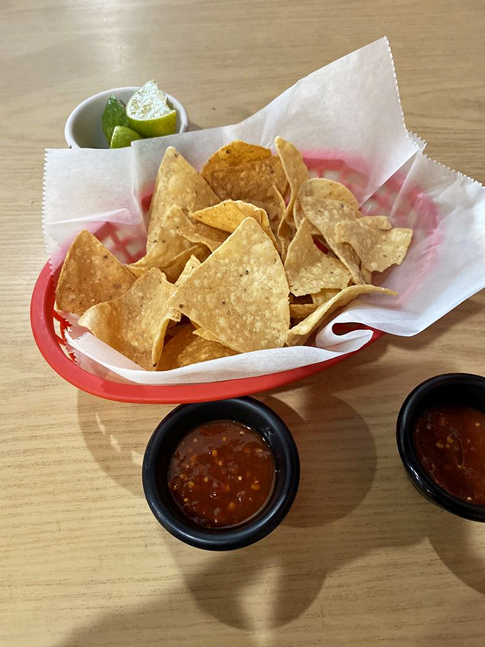 Crispy triangles of joy with salsa that strikes the perfect balance between heat and flavor. That lime wedge isn't just garnish&mdash;it's essential chemistry.