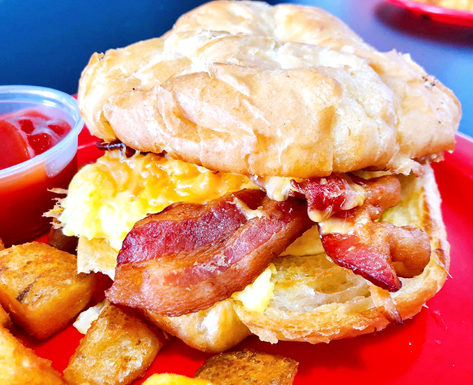 Breakfast sandwich architecture at its finest. That bacon isn't just crispy – it's showing off for the camera.