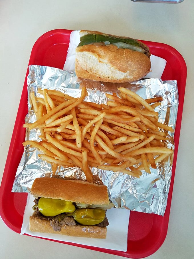 A tray that understands priorities: sandwich as the star, with golden fries as the essential co-star. Simple perfection on a red tray.