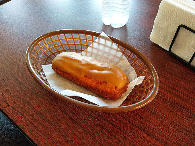 That maple bar isn't just lounging in its basket—it's patiently waiting for its moment to become the highlight of someone's day.