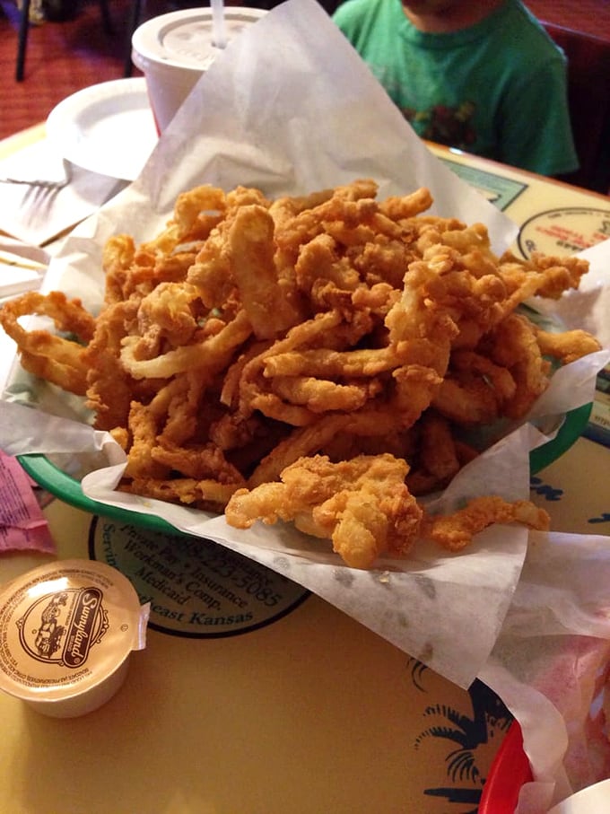 Onion rings piled high in a basket&mdash;each one a golden halo of crunch that shatters delicately with every blissful bite.