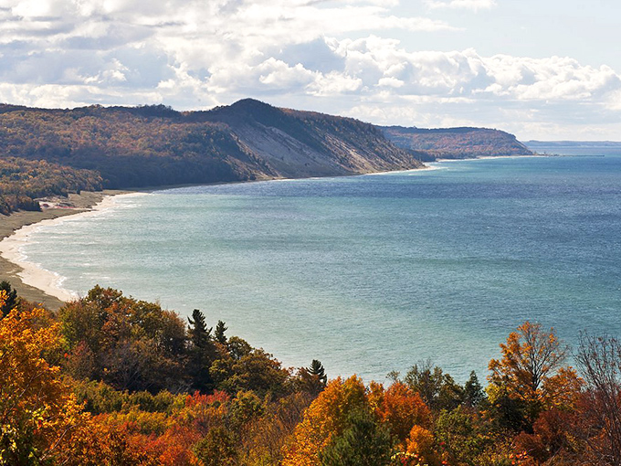 Mother Nature showing off her fall color palette along Lake Michigan's shoreline. Those dunes aren't just scenic—they're geological rock stars dating back thousands of years.