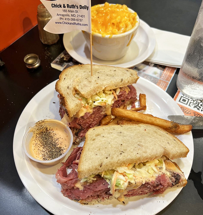 A sandwich that requires jaw exercises before attempting. Pastrami and corned beef stacked higher than most Maryland real estate listings.
