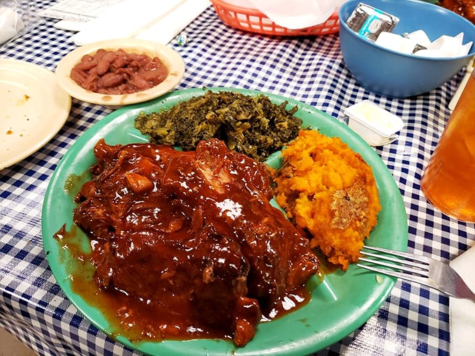 Ribs glistening with sauce that could make you propose marriage to a plate. The sweet potato casserole is just showing off.