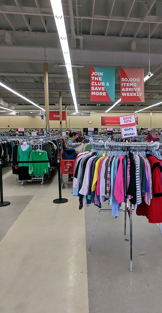 Signs overhead guide you through the retail wilderness, with "50,000 items arrive weekly" serving as both promise and challenge to dedicated thrifters.
