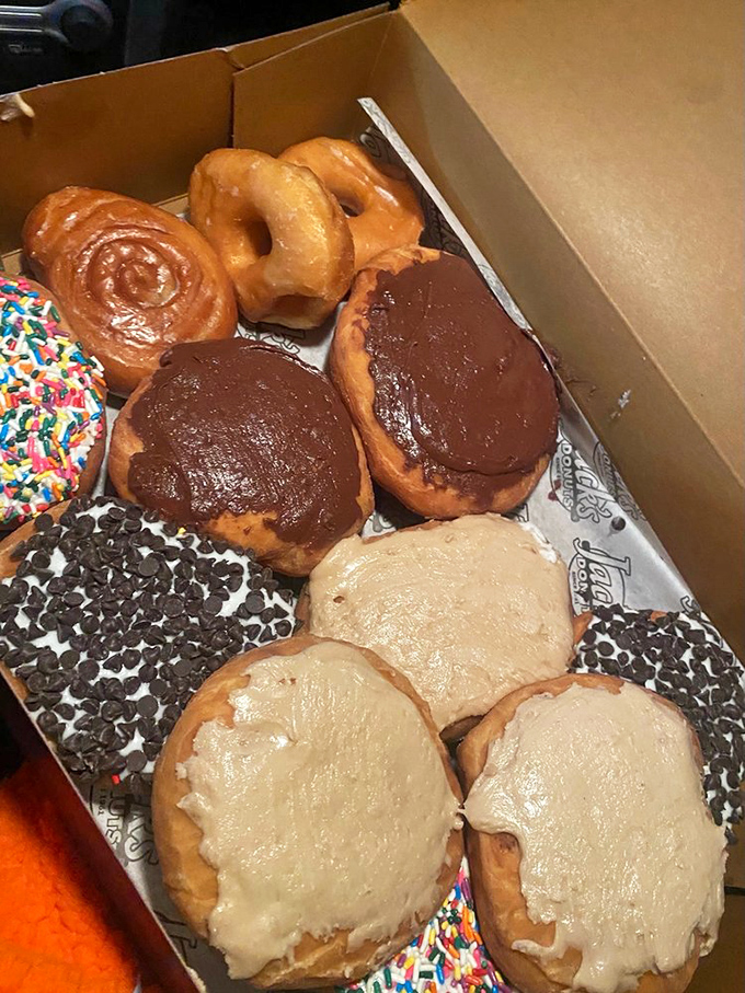 Jack's dozen—a box of possibilities ranging from chocolate-dipped indulgence to sprinkle-crowned joy. Diet plans tremble at the sight.