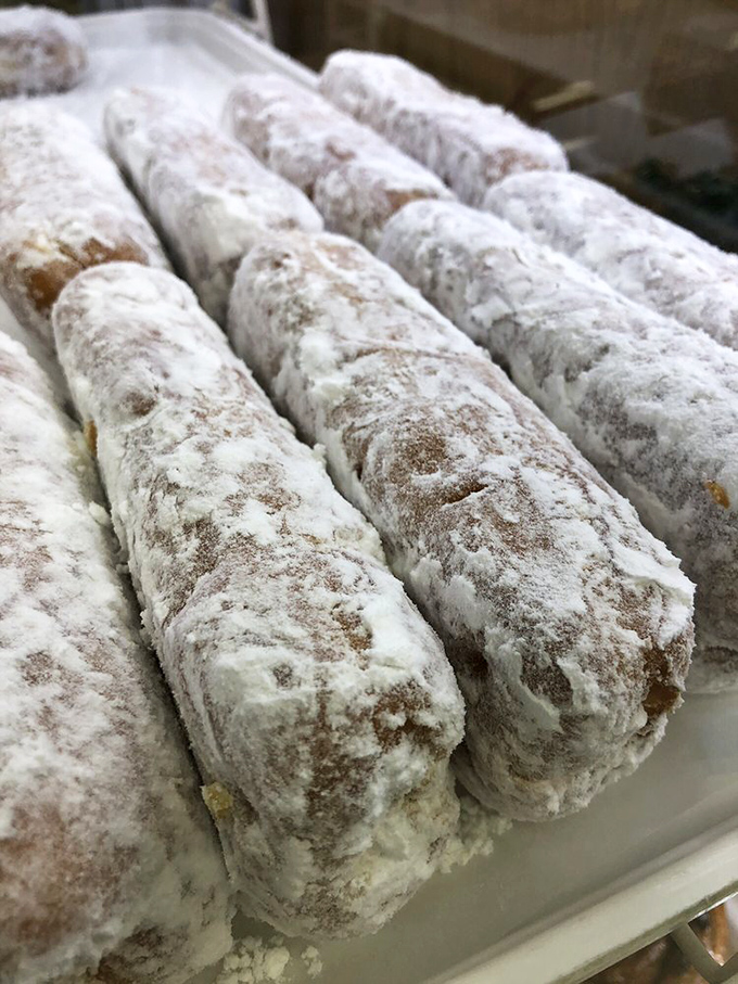 These powdered pastry submarines hide creamy treasures within&mdash;like dessert torpedoes aimed straight at your willpower.