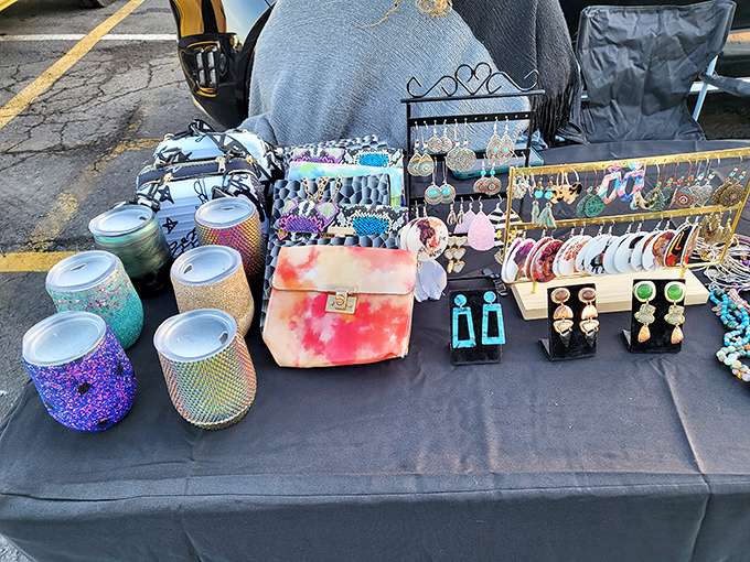 Handcrafted accessories spread across outdoor tables catch the sunlight. Someone's passion project becomes your next conversation starter.