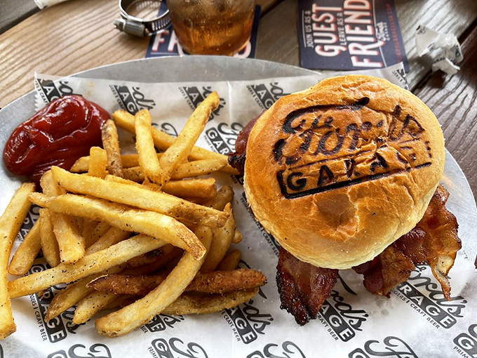 The burger arrives branded with Ford's logo&mdash;a delicious form of automotive ownership. Those fries look crispy enough to trigger a custody battle at the table.