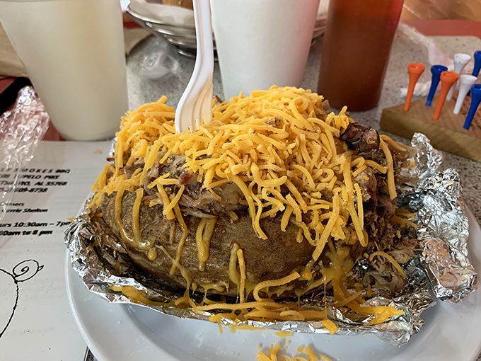 Not just a baked potato &ndash; a canvas for barbecue artistry. That melted cheese is like a comfort blanket for the savory treasure beneath.