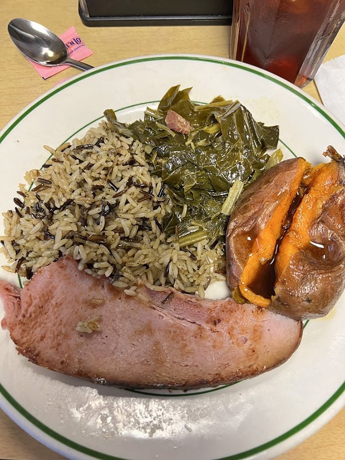 Southern comfort on a plate: baked ham keeping company with wild rice and greens. The kind of meal that makes you want to find a porch swing afterward.