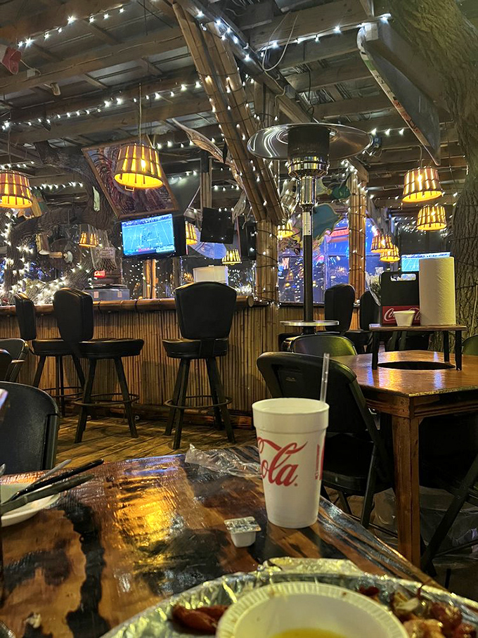The bar area glows with amber light at night, transforming from seafood joint to coastal wonderland where stories flow as freely as the drinks.