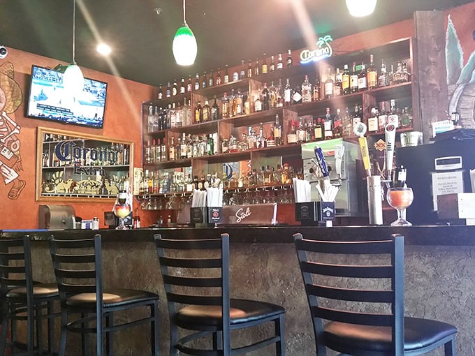 The well-stocked bar promises liquid happiness in various forms. That "We ID Everyone" sign suggests their margaritas pack a punch worth checking IDs for.