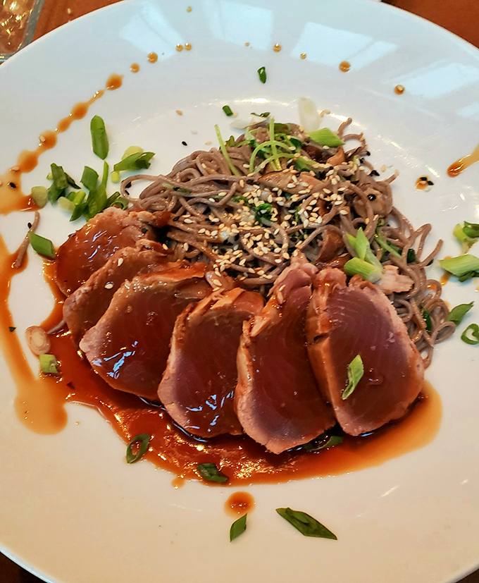 Rare tuna slices fanned out like a deck of cards dealt by a chef who knows exactly how to play your taste buds.