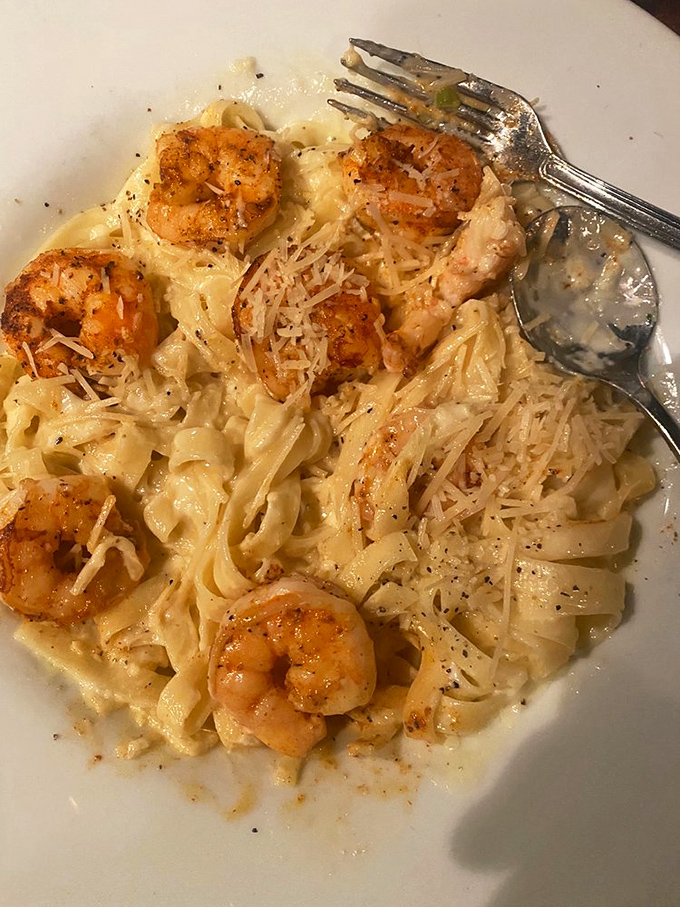 Blackened shrimp perform a delicate ballet across creamy fettuccine &ndash; pasta that would make Neptune himself swim upstream for a bite.