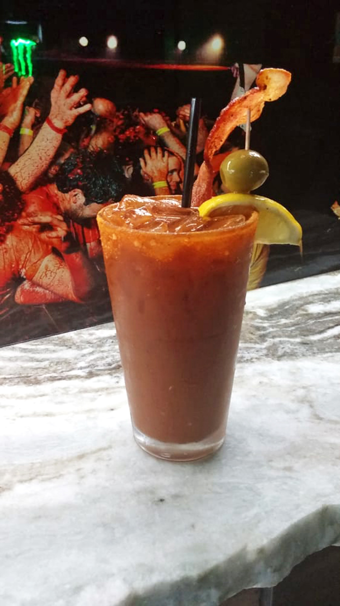 This Bloody Mary comes with a strip of bacon that's clearly trying to escape. Can't blame it.