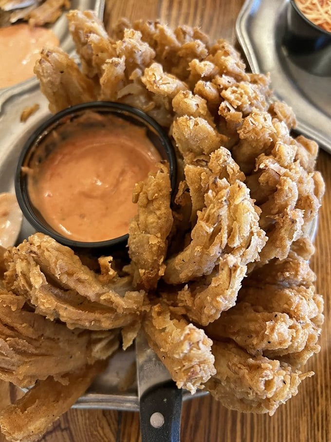 The Blooming Onion: where a humble vegetable transforms into a golden, crispy flower of flavor that makes regular onion rings look positively uninspired.