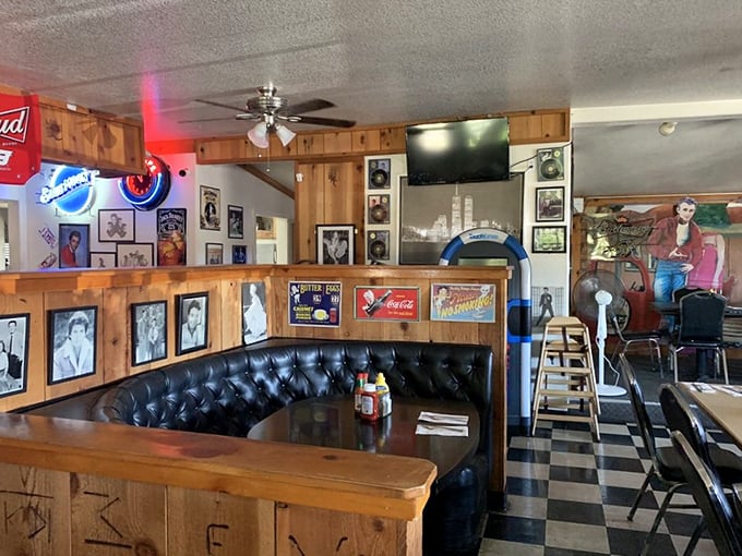 The black leather booth practically whispers "sit a while" as vintage memorabilia creates the perfect backdrop for both conversation and contemplation.
