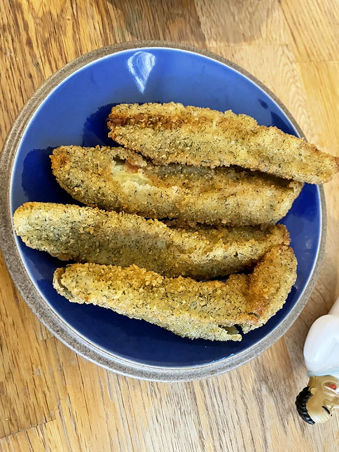 Crispy fish fillets that would make even non-seafood fans reconsider their life choices. Golden, crunchy coating protecting tender, flaky fish within.