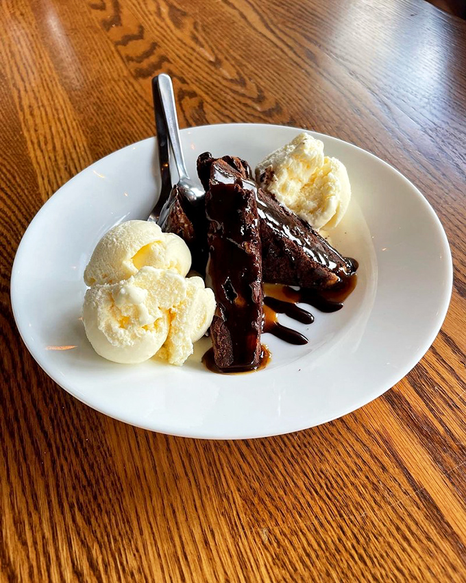 Dessert that demands a moment of silence. Warm chocolate brownie swimming in caramel sauce with vanilla ice cream melting into the crevices. Heaven.