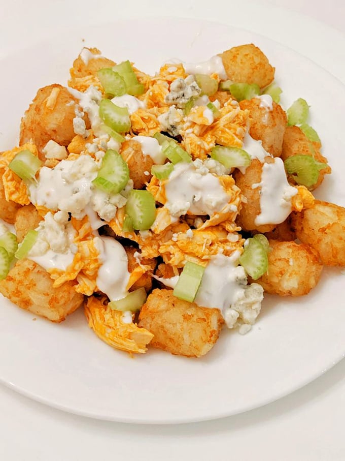 Buffalo chicken meets tater tots in a culinary blind date that was clearly meant to be. Blue cheese crumbles seal this delicious deal.