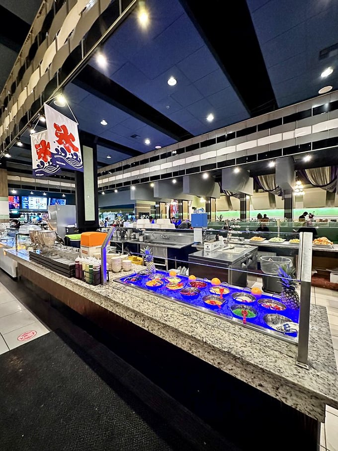 The buffet area's sleek design features elegant lighting and blue accents, elevating the all-you-can-eat experience beyond fluorescent cafeteria vibes.