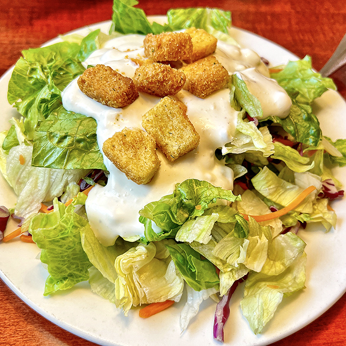 This Caesar salad isn't just dressed&mdash;it's wearing its Sunday best. Crisp romaine baptized in creamy dressing with crunchy crouton companions.