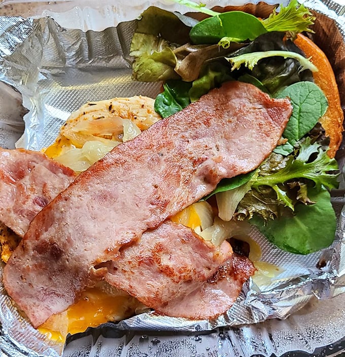 A sandwich that requires both hands and your full attention. Layers of flavor between bread that knows its supporting role.