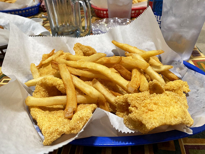The blue basket might be plastic, but what it holds is pure gold. Catfish, fries, and the promise of a food coma worth every minute.