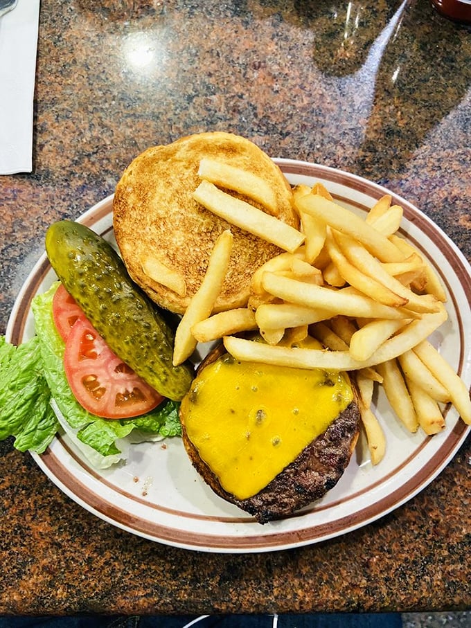 When a burger comes with a pickle spear that impressive, you know you're in a diner that understands the importance of proper proportions.