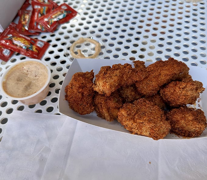 These aren't your drive-thru nuggets. Each golden morsel is a miniature masterpiece of crunch and tenderness, waiting to be dunked in that ambrosial sauce.