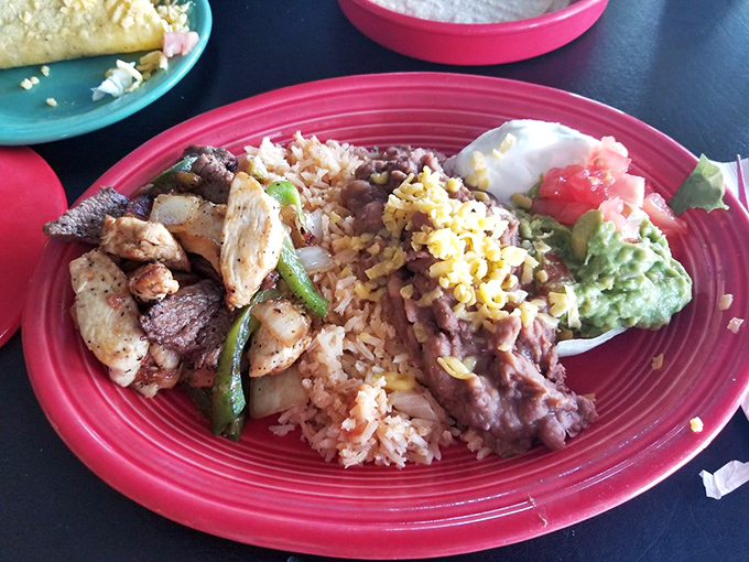 A colorful fiesta on a plate: sizzling chicken and steak fajitas with all the fixings that make decision-making deliciously difficult.