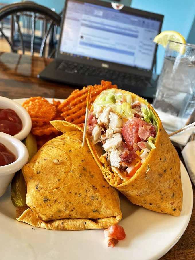 This wrap doesn't just contain chicken&mdash;it embraces it in a warm tortilla hug, with crispy fries standing guard nearby.