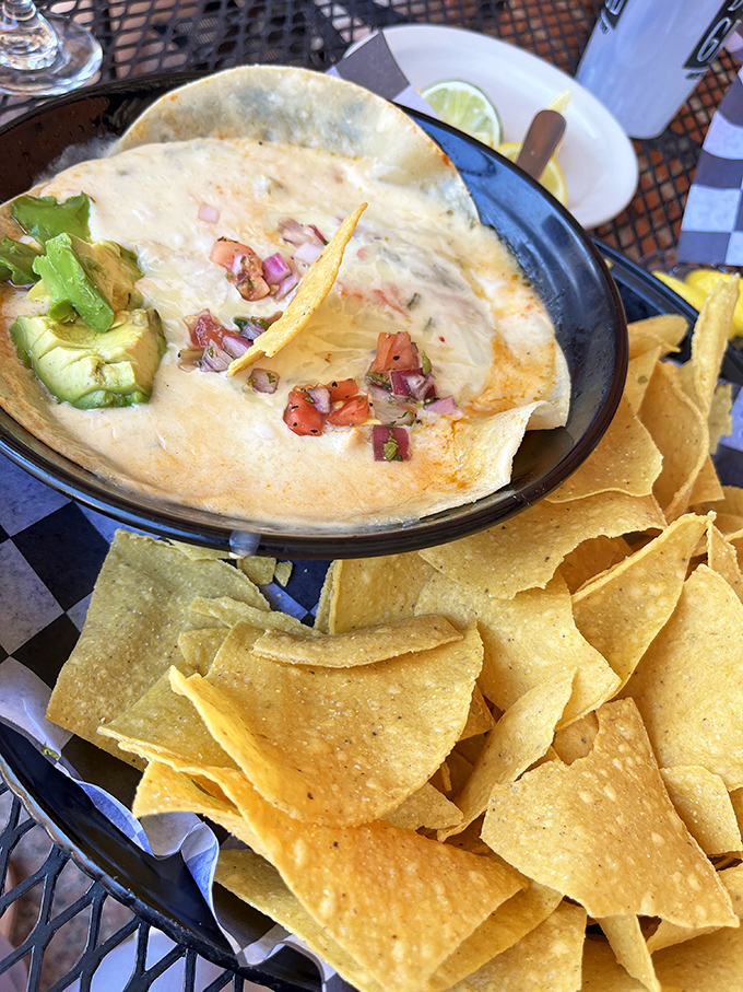 The enchilada dip arrives like a molten cheese volcano surrounded by crisp tortilla chip mountains. Resistance is both futile and foolish.
