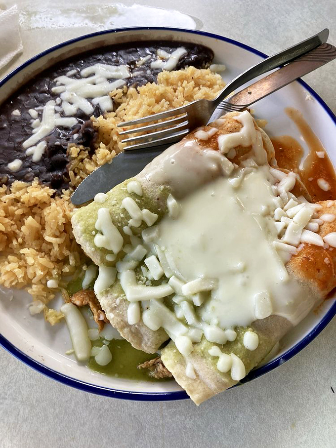 These enchiladas aren't just covered in cheese&mdash;they're embraced by it, swimming in a sea of melty goodness alongside rice and beans.