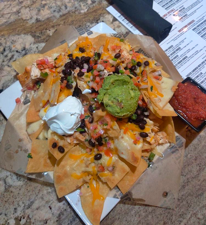 These nachos aren't just a snack&mdash;they're a celebration. That mountain of cheese, beans, and guacamole is basically joy in physical form.