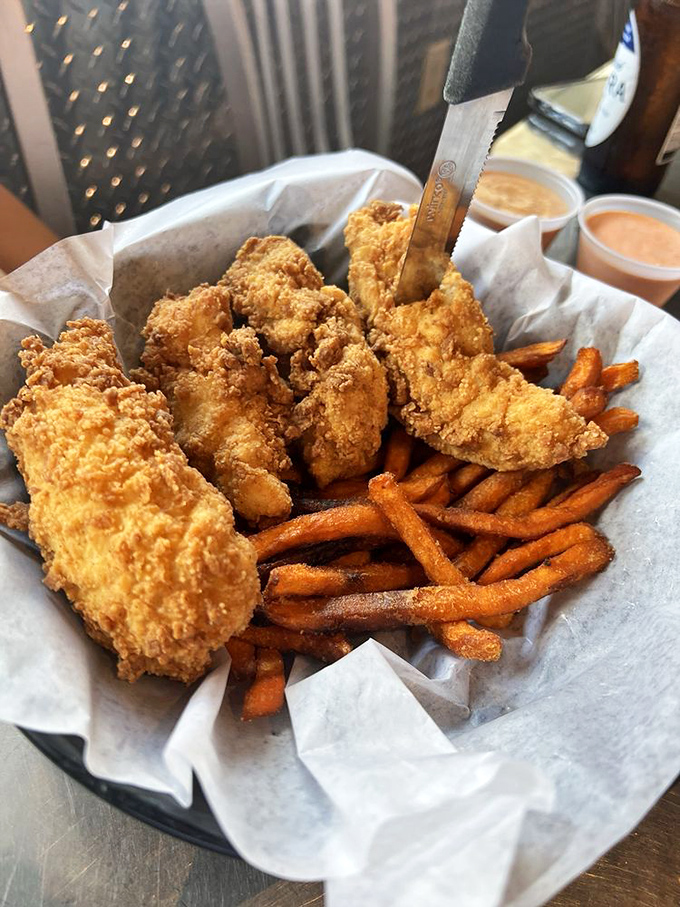 Chicken tenders that could make a vegetarian question their life choices, nestled alongside sweet potato fries that taste like autumn sunshine.