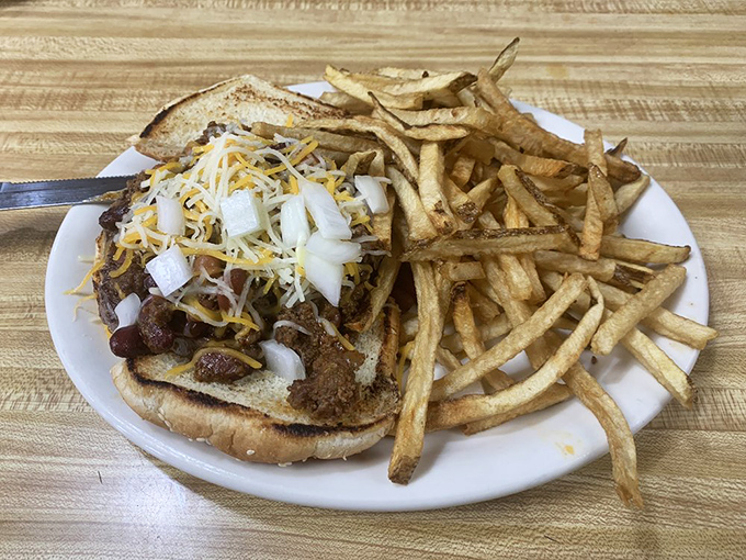 This isn't just a burger, it's a mountain of chili, cheese, and onions with architectural integrity that would make Frank Lloyd Wright proud.