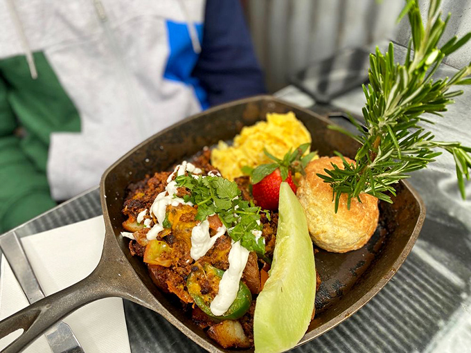 The chorizo hash arrives in its own skillet universe where eggs, peppers, and potatoes orbit around spicy sausage gravity. Biscuit moon included.