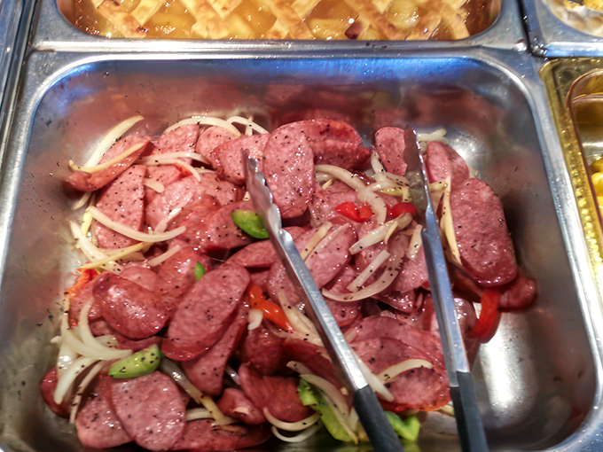 Sausage slices mingling with peppers and onions &ndash; a party in a pan where everyone's invited and spice is the guest of honor.