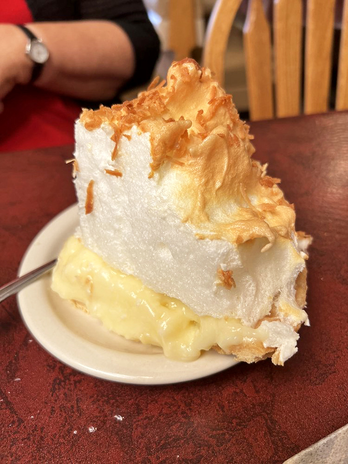 Cloud-like meringue floating above custard so rich it should have its own tax bracket. Coconut cream pie elevated to art form.