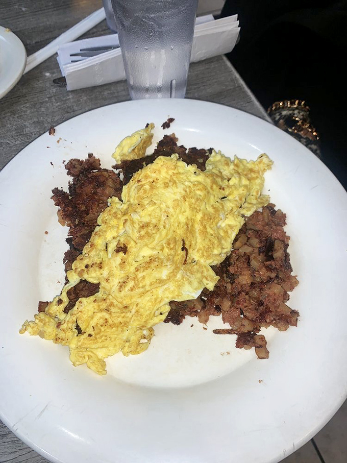 Corned beef hash supporting fluffy scrambled eggs like a sturdy foundation&mdash;this is breakfast architecture that would make Frank Lloyd Wright reach for a fork.