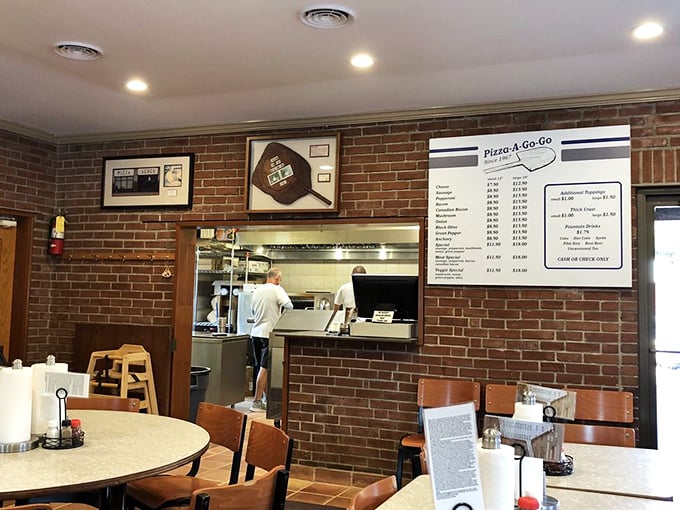 Behind the scenes where pizza magic happens, the kitchen window offers a glimpse into decades of delicious consistency.