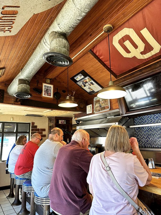 The wood-paneled ceiling and University of Oklahoma pride create the perfect Oklahoma backdrop for burger enlightenment.