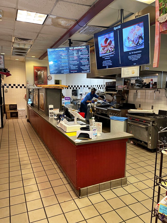 Where sandwich magic happens – the open kitchen design lets you witness your lunch being born.