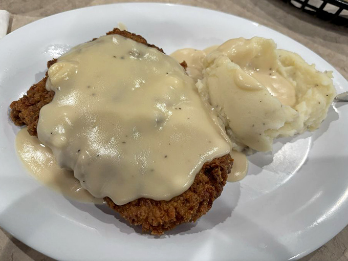 Country fried steak swimming in creamy gravy&mdash;the kind of dish that makes you want to hug the cook and take a nap afterward.