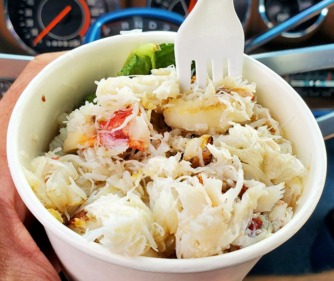 Crab that looks like it was swimming this morning, now resting on a bed of shredded cabbage—the ocean-to-table journey at its finest.