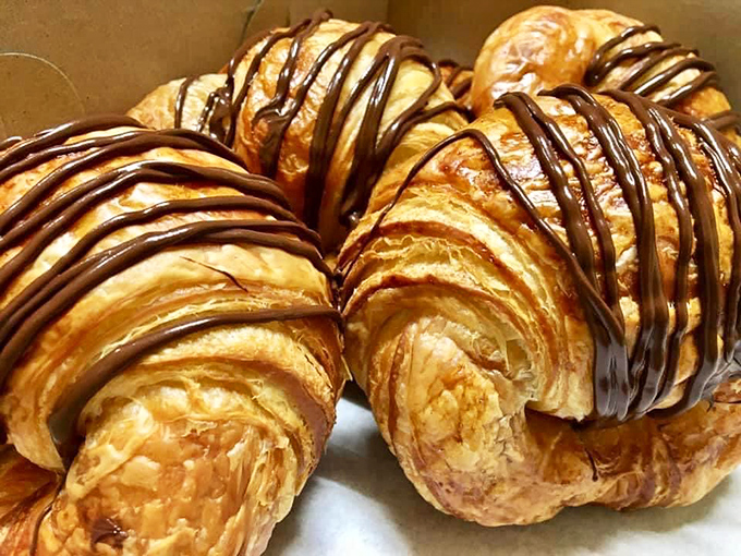 Croissants with chocolate drizzle that practically whisper "Bonjour" as you bite into layers so flaky they should be considered a natural wonder.