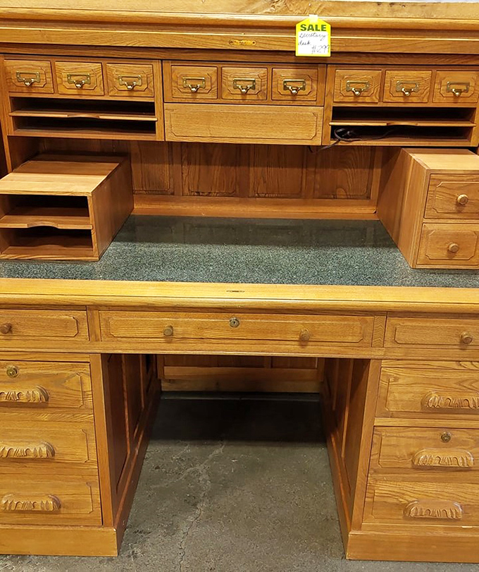 Craftsmanship from another era - this solid wood desk with multiple drawers offers both beauty and functionality for a home office.