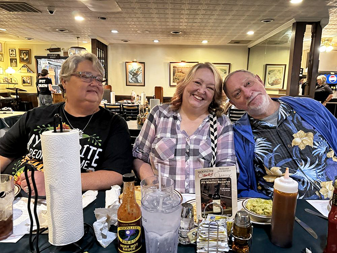 Happy diners sharing stories and sauce-stained napkins. Notice the roll of paper towels&mdash;this place understands the serious business of barbecue.